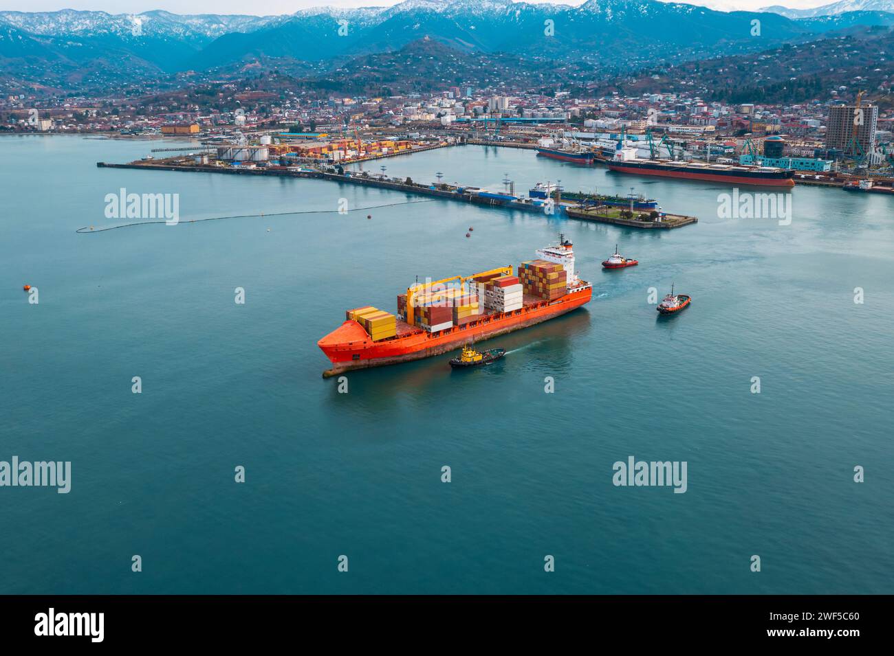 Aerial view of cargo ship carrying containers for import and export, business logistic and ...