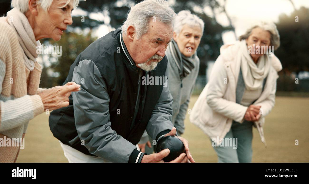 Senior man, game and senior people bowling in nature for retirement ...