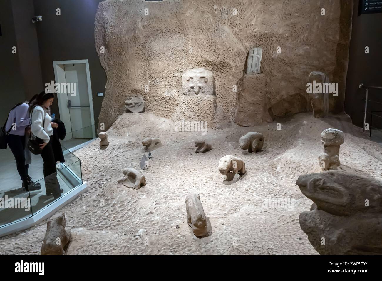 Visitors looking at Animal statues, limestone, Neolith, Göbeklitepe ...