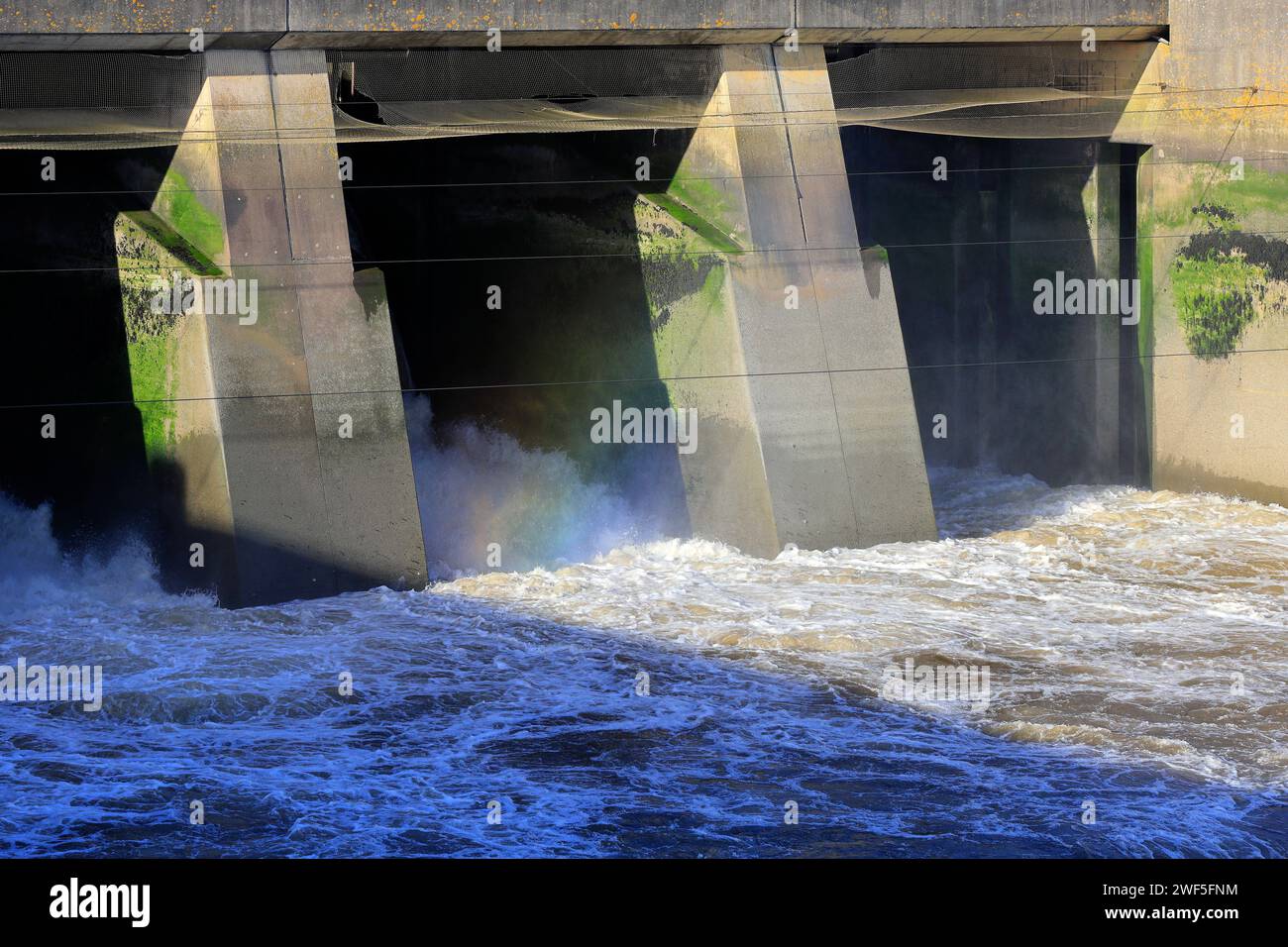Cardiff Barrage sea gates overflow into the sea with small rainbow ...