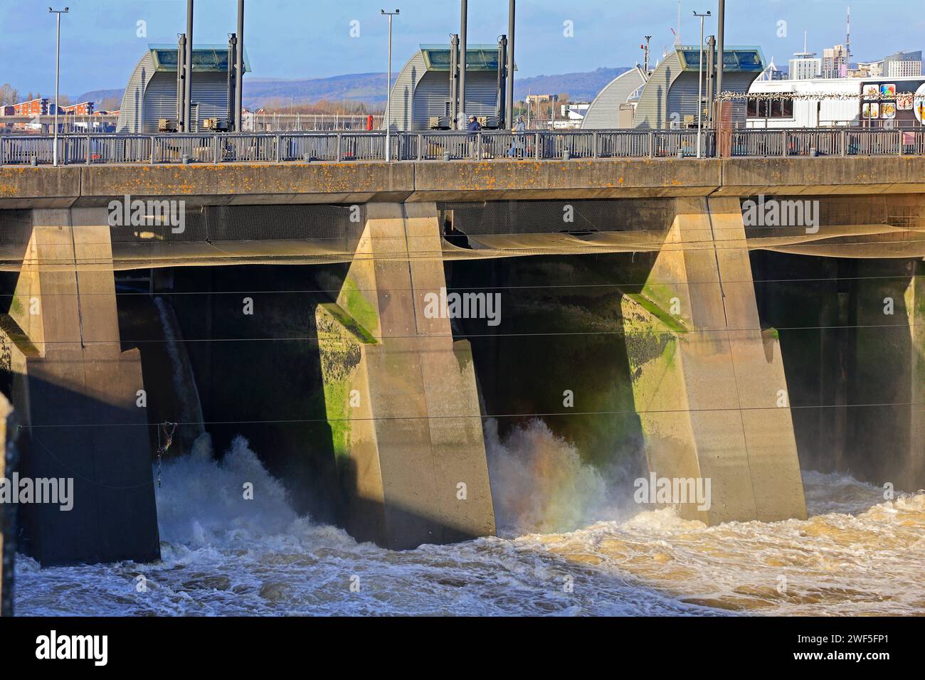 Cardiff Barrage sea gates overflow into the sea with small rainbow ...