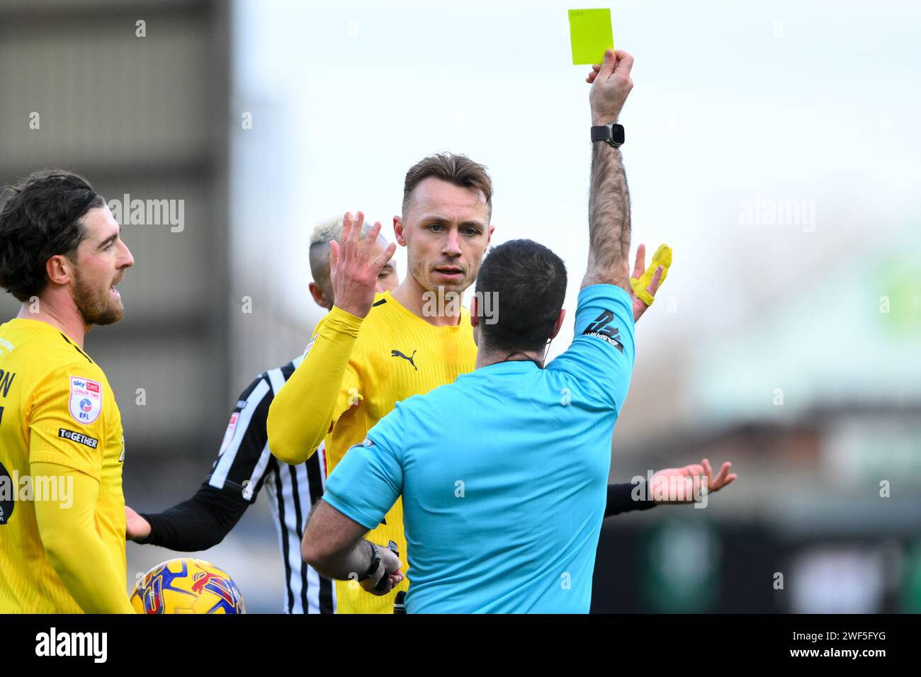 Referee, Alex Chilowicz shows a yellow card for unsporting behaviour to ...