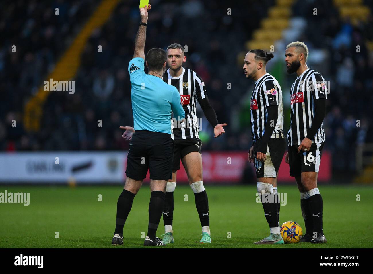 Referee, Alex Chilowicz shows a yellow card to Aden Baldwin of Notts ...