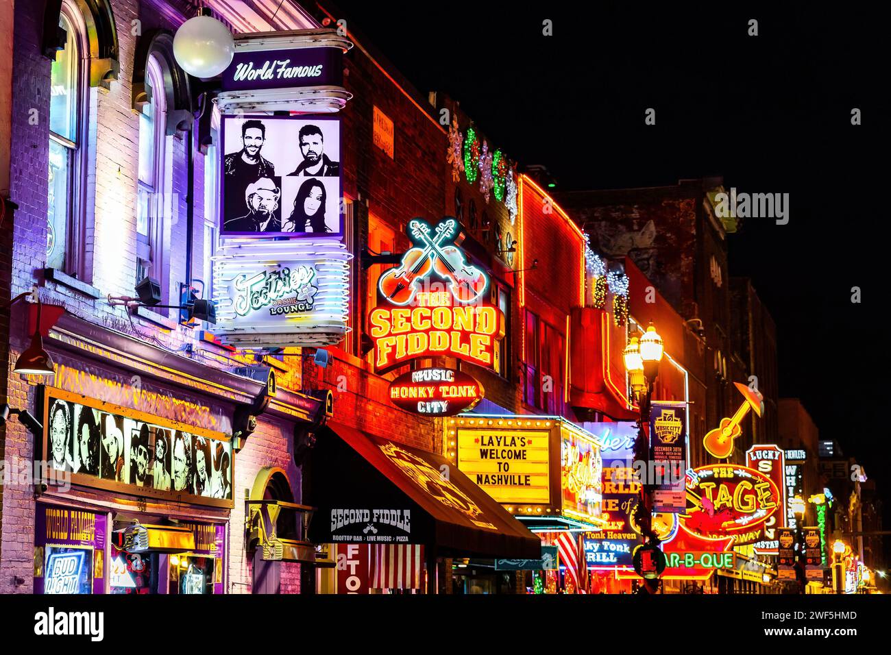 Nashville, TN, USA - 12-24-2023: Famous Neon signs of blues clubs on Beale street illuminated at ...