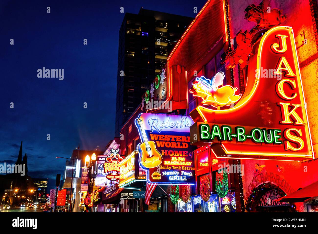 Nashville, TN, USA - 12-24-2023: Famous Neon signs of blues clubs on Beale street illuminated at ...