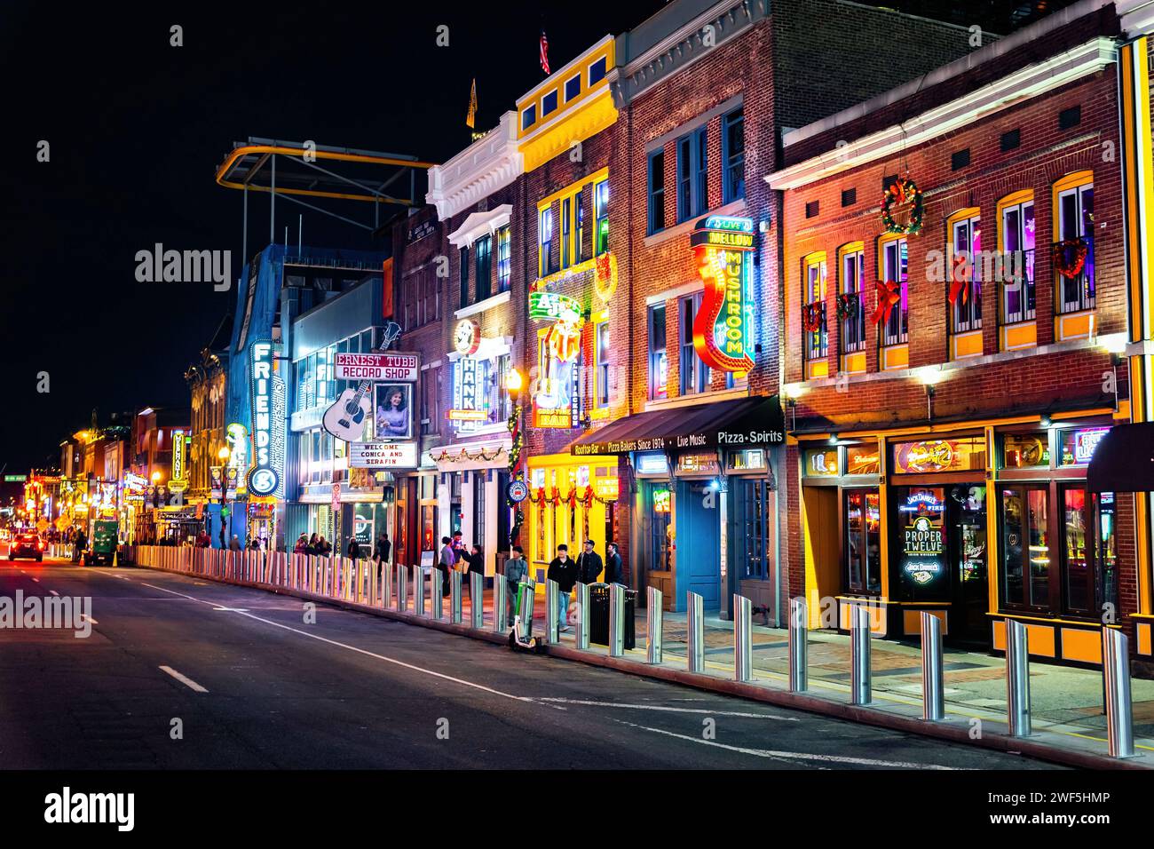Nashville, TN, USA - 12-24-2023: Famous Neon signs of blues clubs on Beale street illuminated at ...
