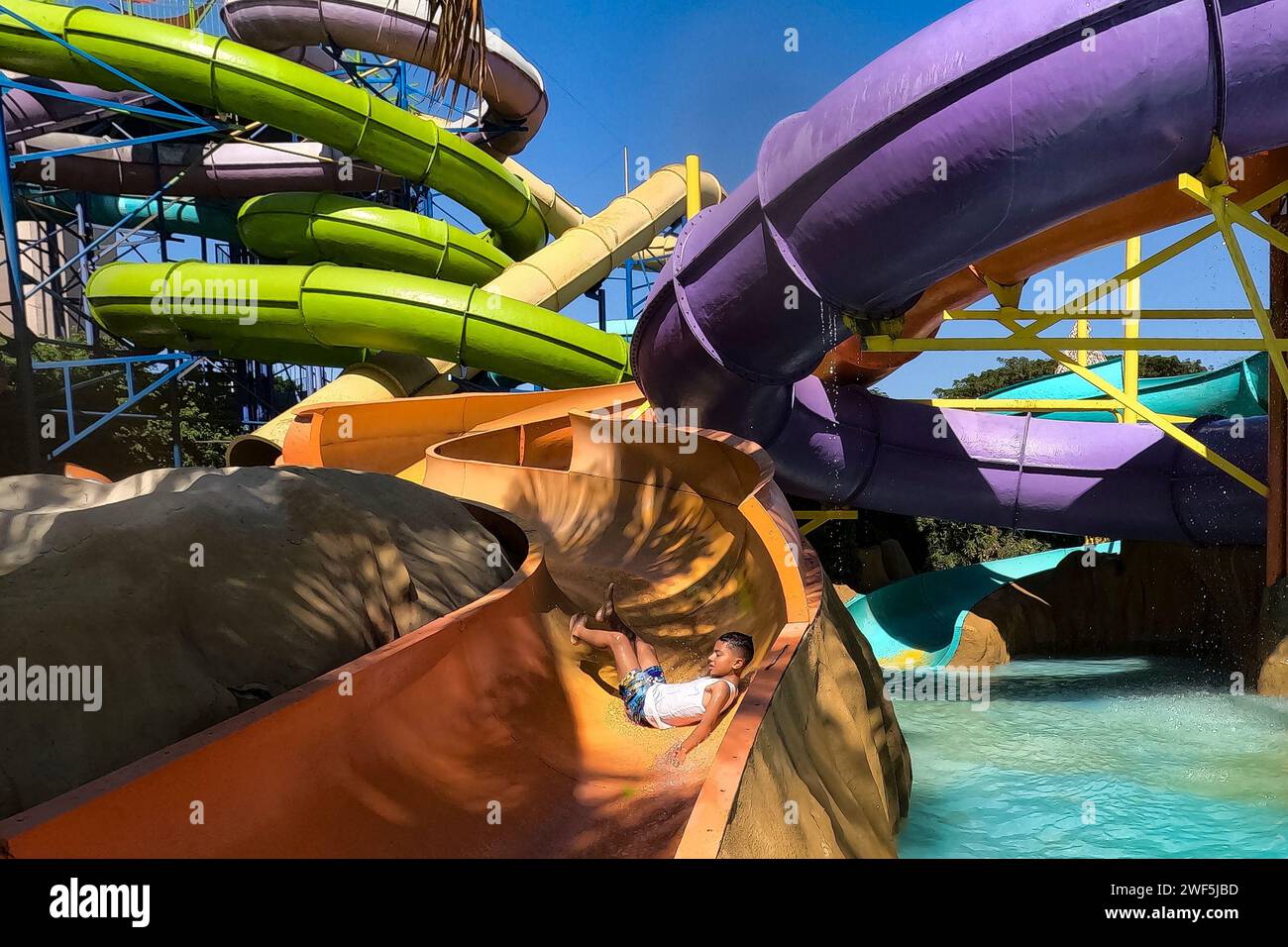 A boy slides down on a waterslide at the Parque Dunas water park in ...