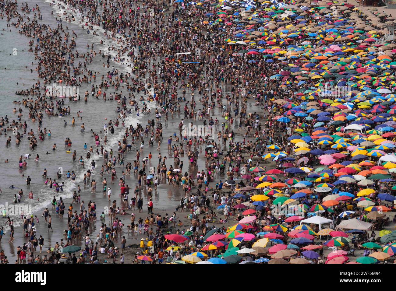Beachgoers crowd the Agua Dulce beach in Lima, Peru, Sunday, Jan. 28 ...