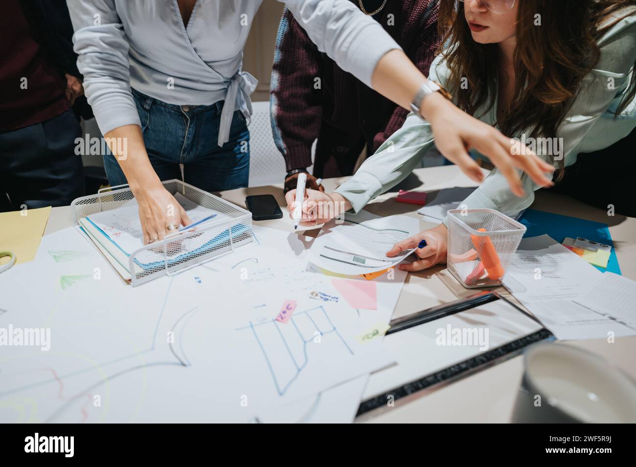 A dynamic team of employees engage in a productive brainstorming ...