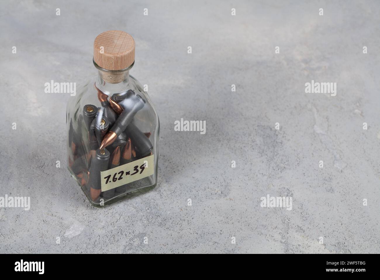 kalashnikov 7.62mm bullets in glass jar on grey concrete surface ...