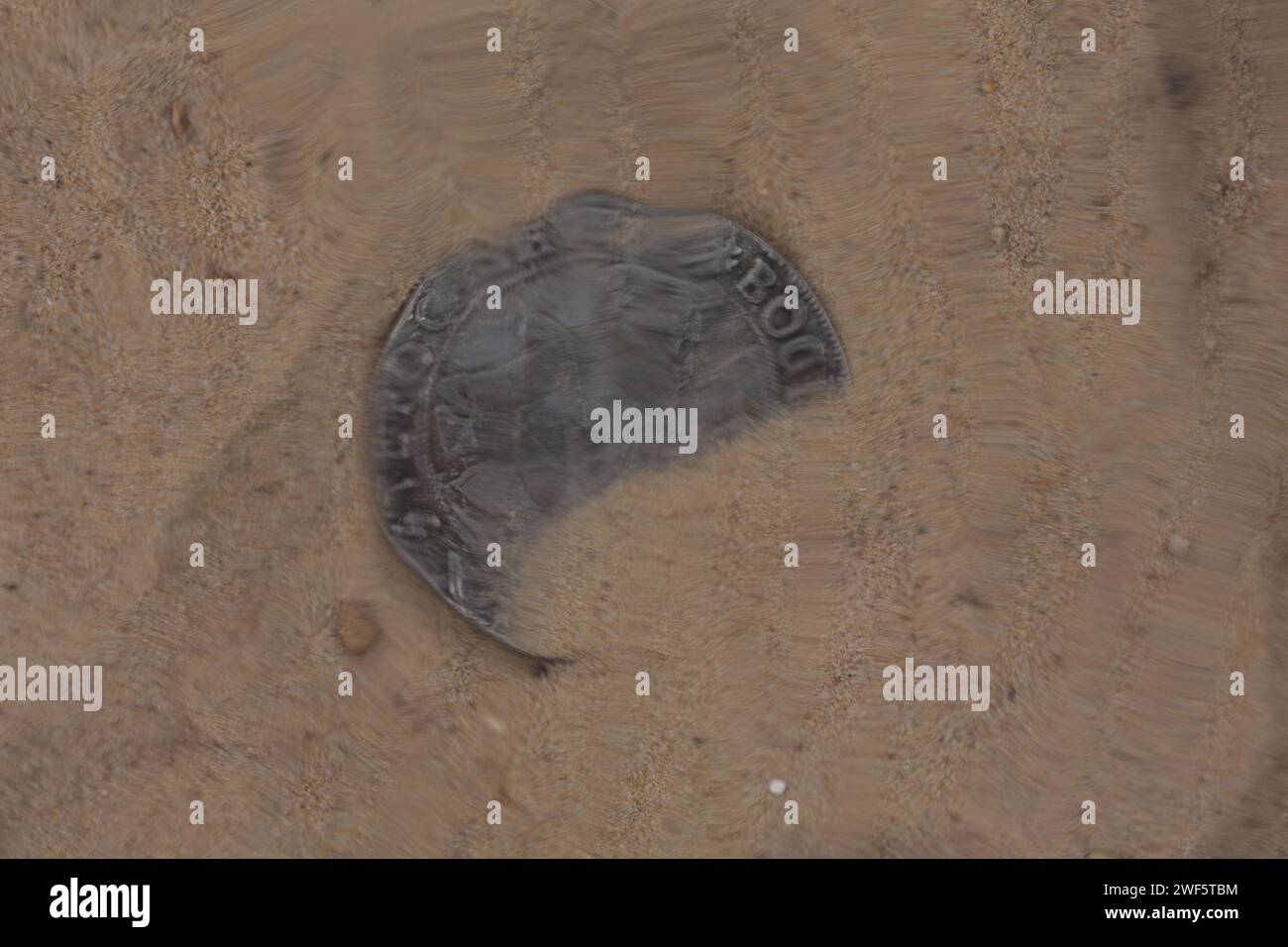 coin in sand under the water background Stock Photo - Alamy
