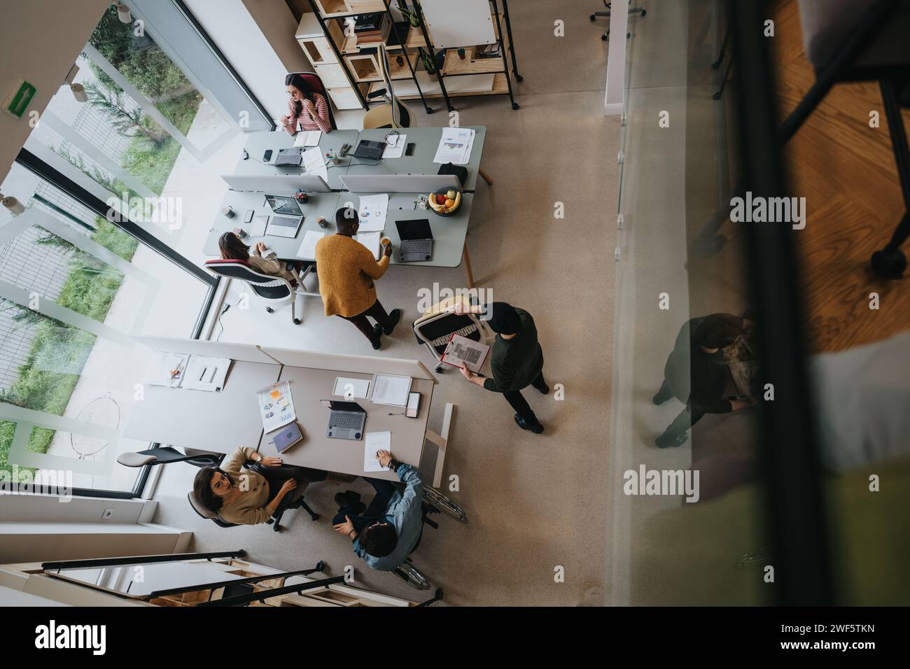Modern open-plan office space with busy working professionals ...
