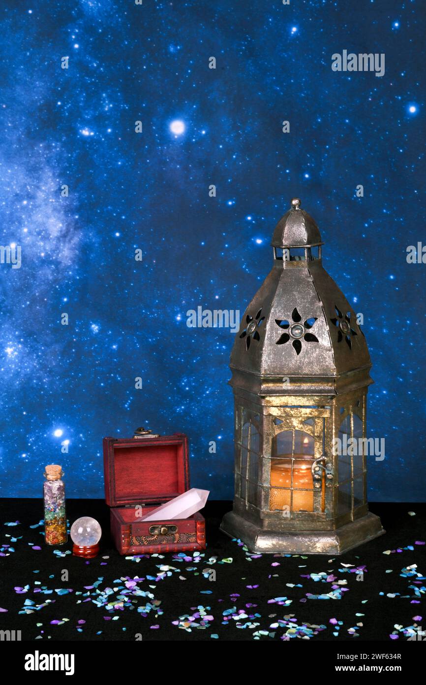 Crystals and gemstones sit next to a lantern as metaphysical symbols ...