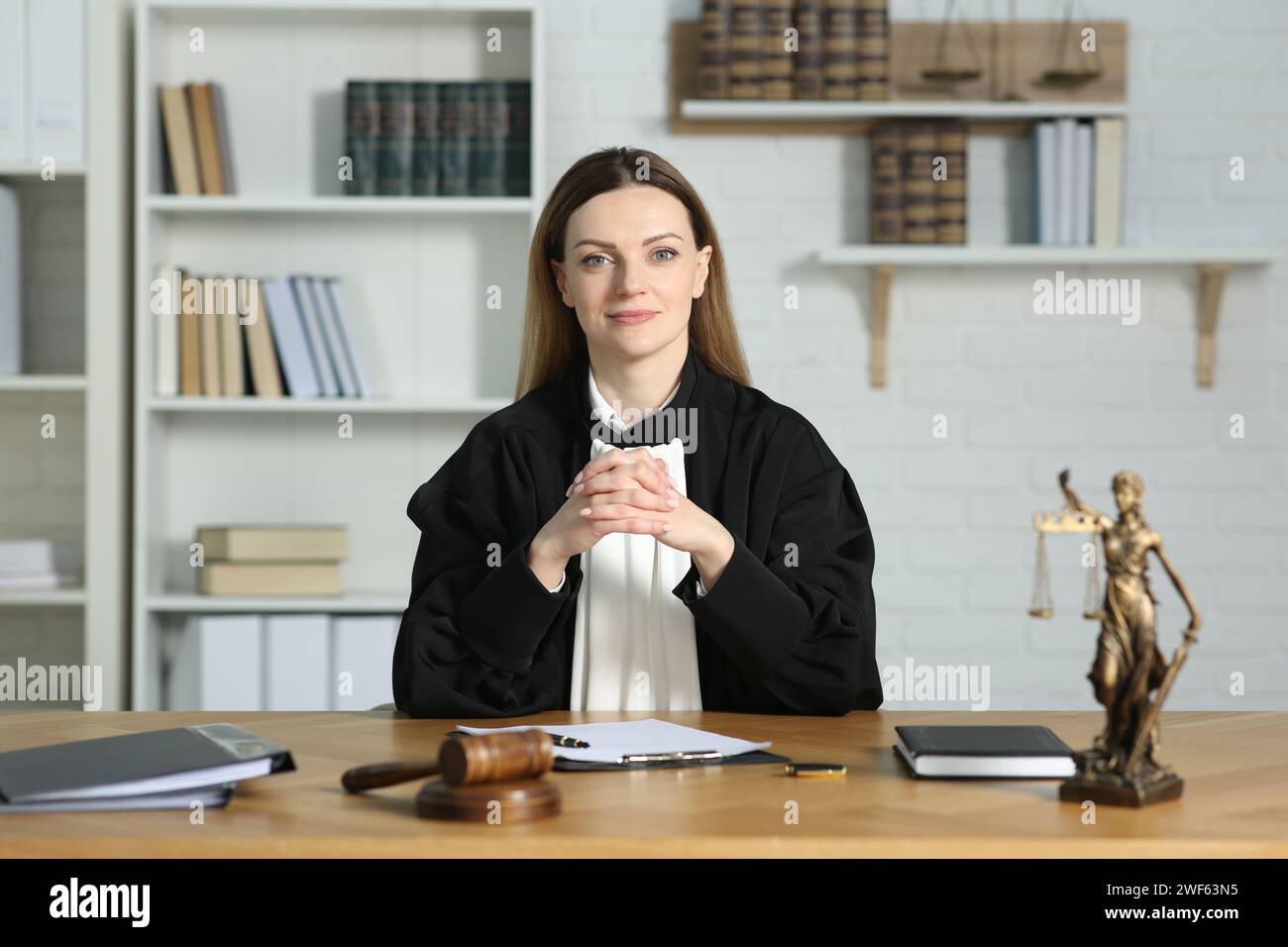 Portrait of judge in court dress at table indoors Stock Photo - Alamy