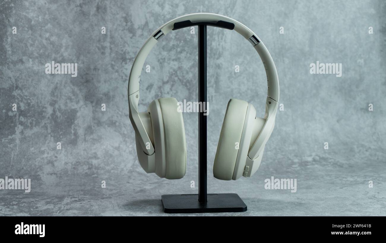 White headphones on a gray table with concrete texture Stock Photo - Alamy