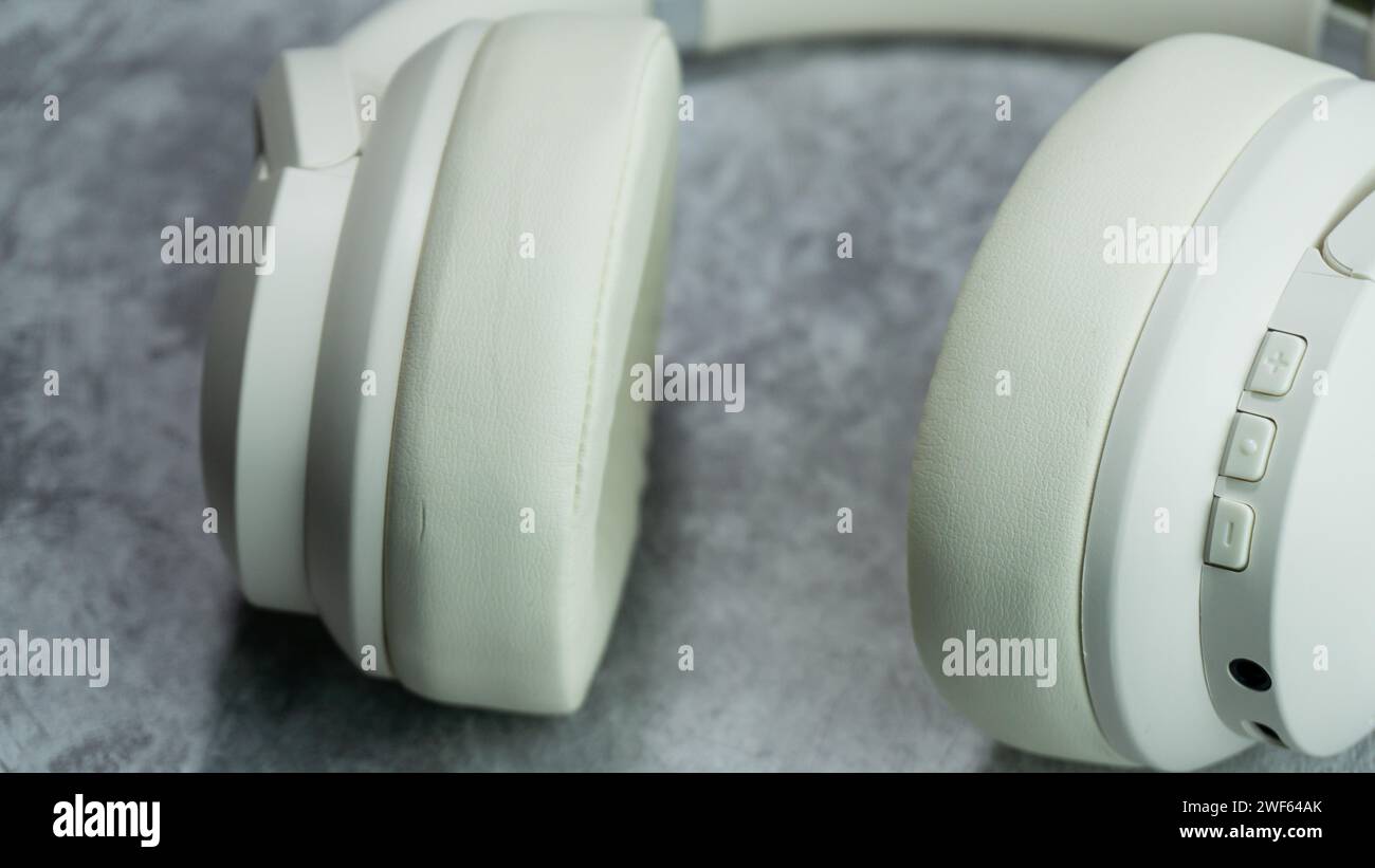 White headphones on a gray table with concrete texture Stock Photo - Alamy