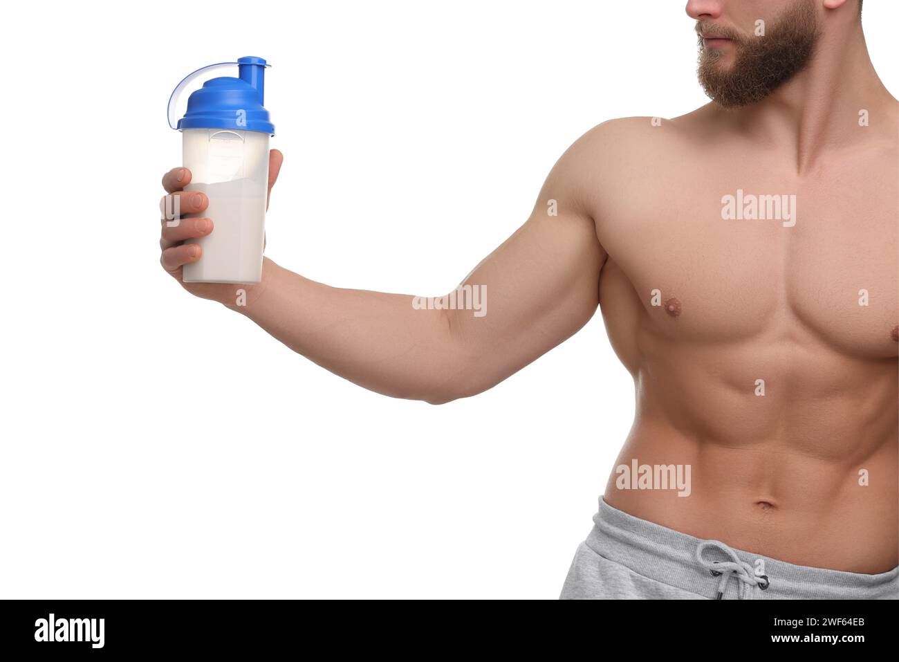 Young man with muscular body holding shaker of protein on white ...