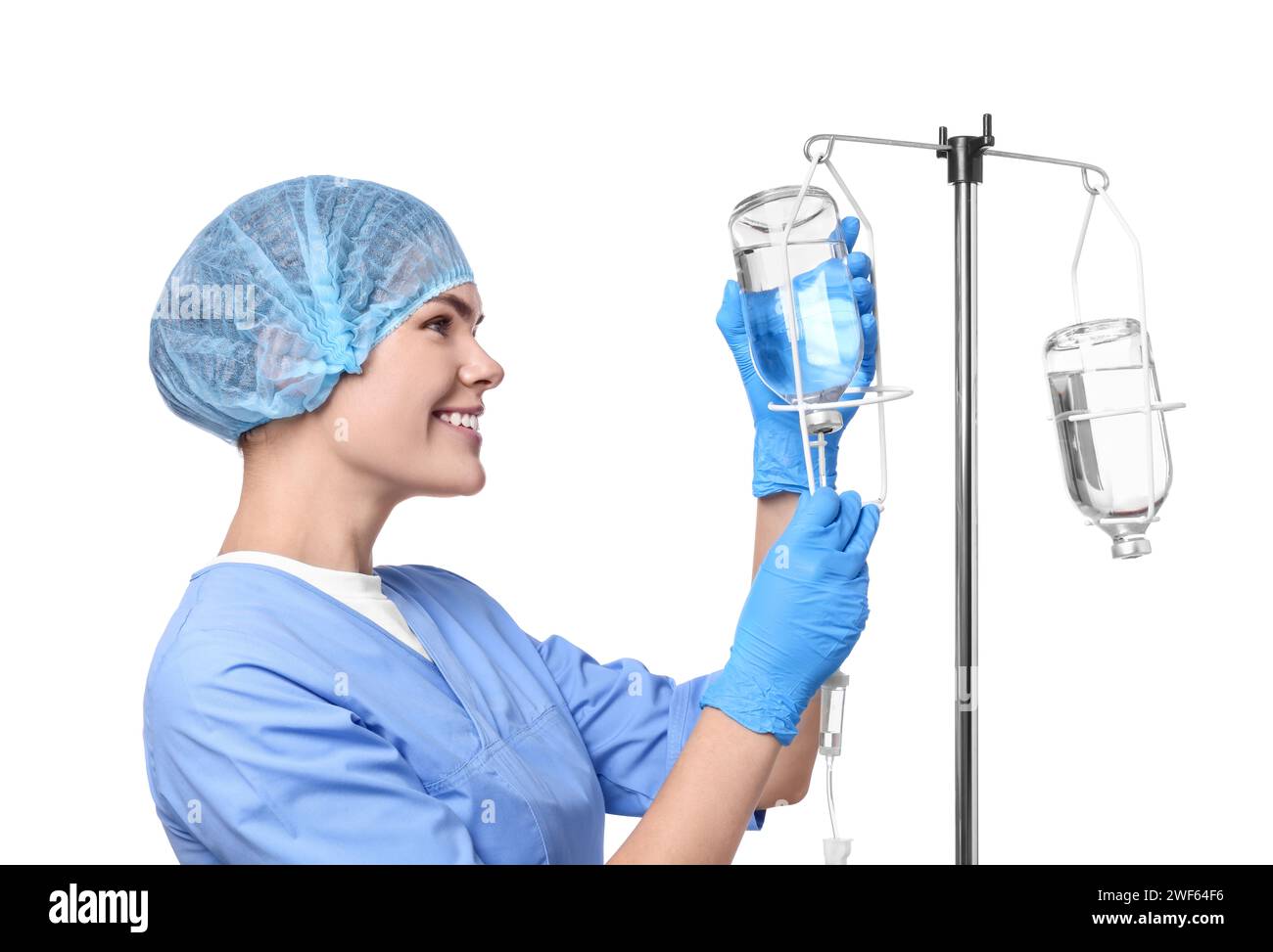 Nurse setting up IV drip on white background Stock Photo - Alamy