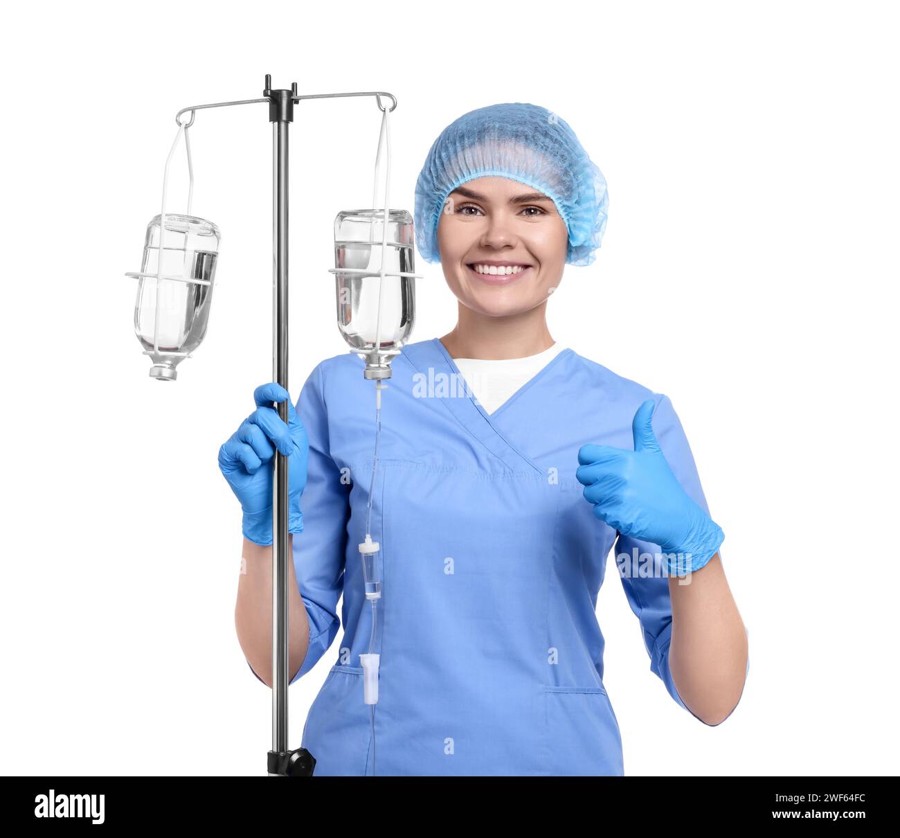 Nurse setting up IV drip on white background Stock Photo - Alamy
