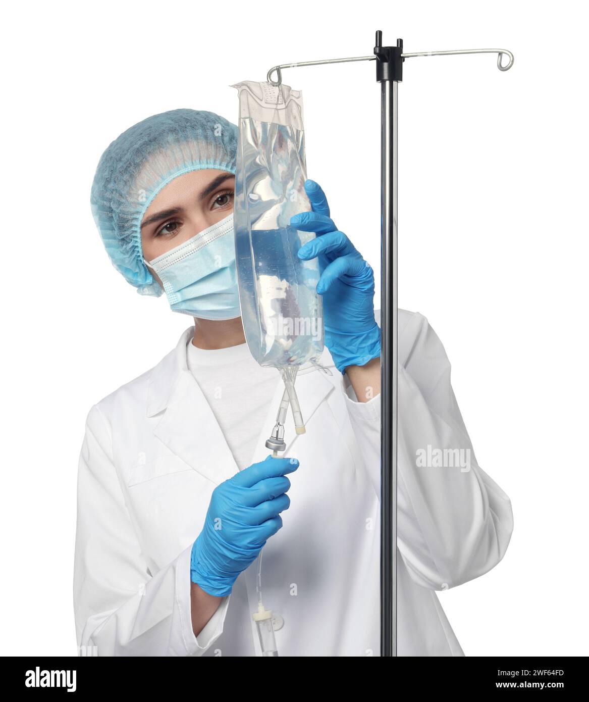 Nurse setting up IV drip on white background Stock Photo - Alamy