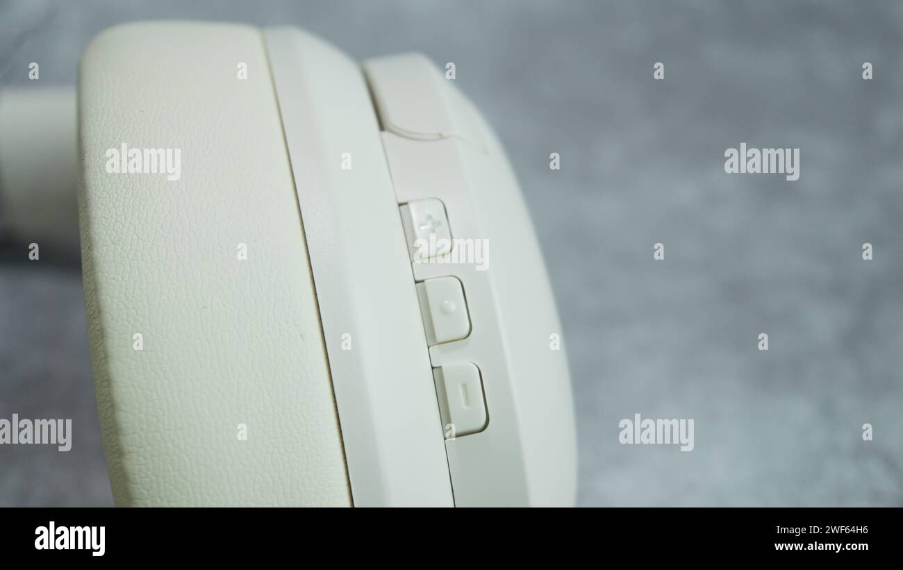 White headphones on a gray table with concrete texture Stock Photo - Alamy