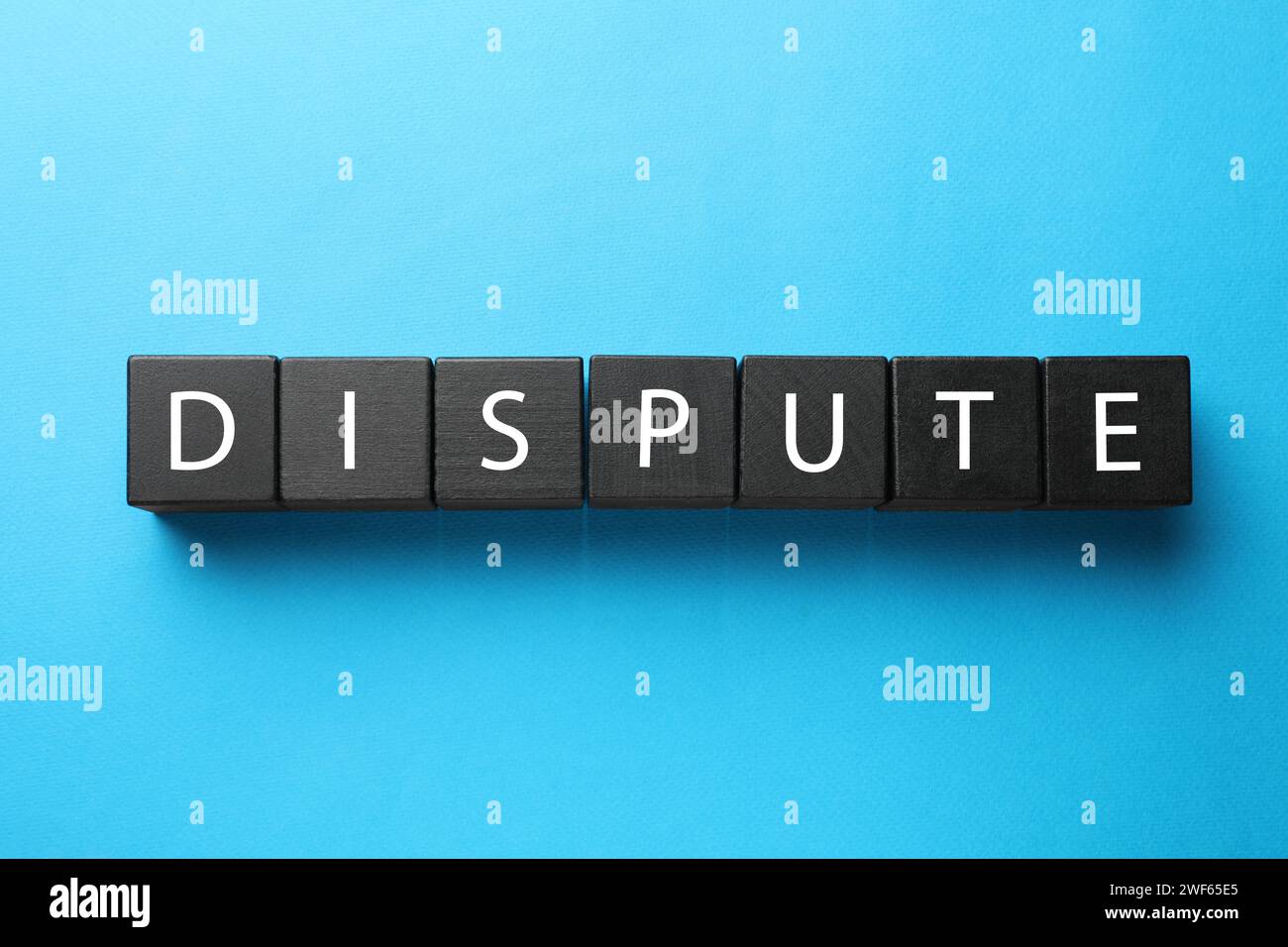 Word Dispute made with black cubes on light blue background, top view ...