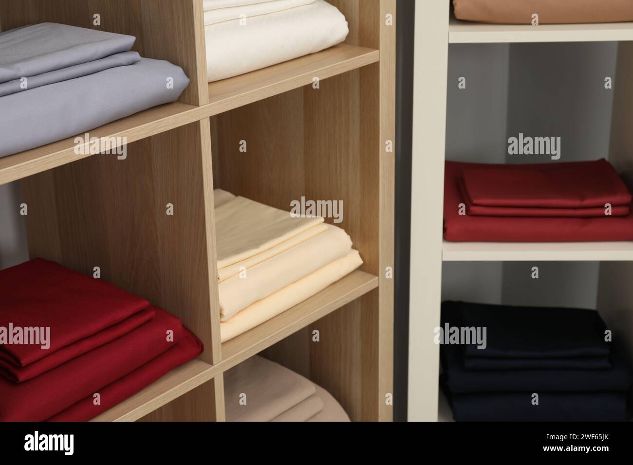 Different colorful bed linens on display in home textiles store Stock ...