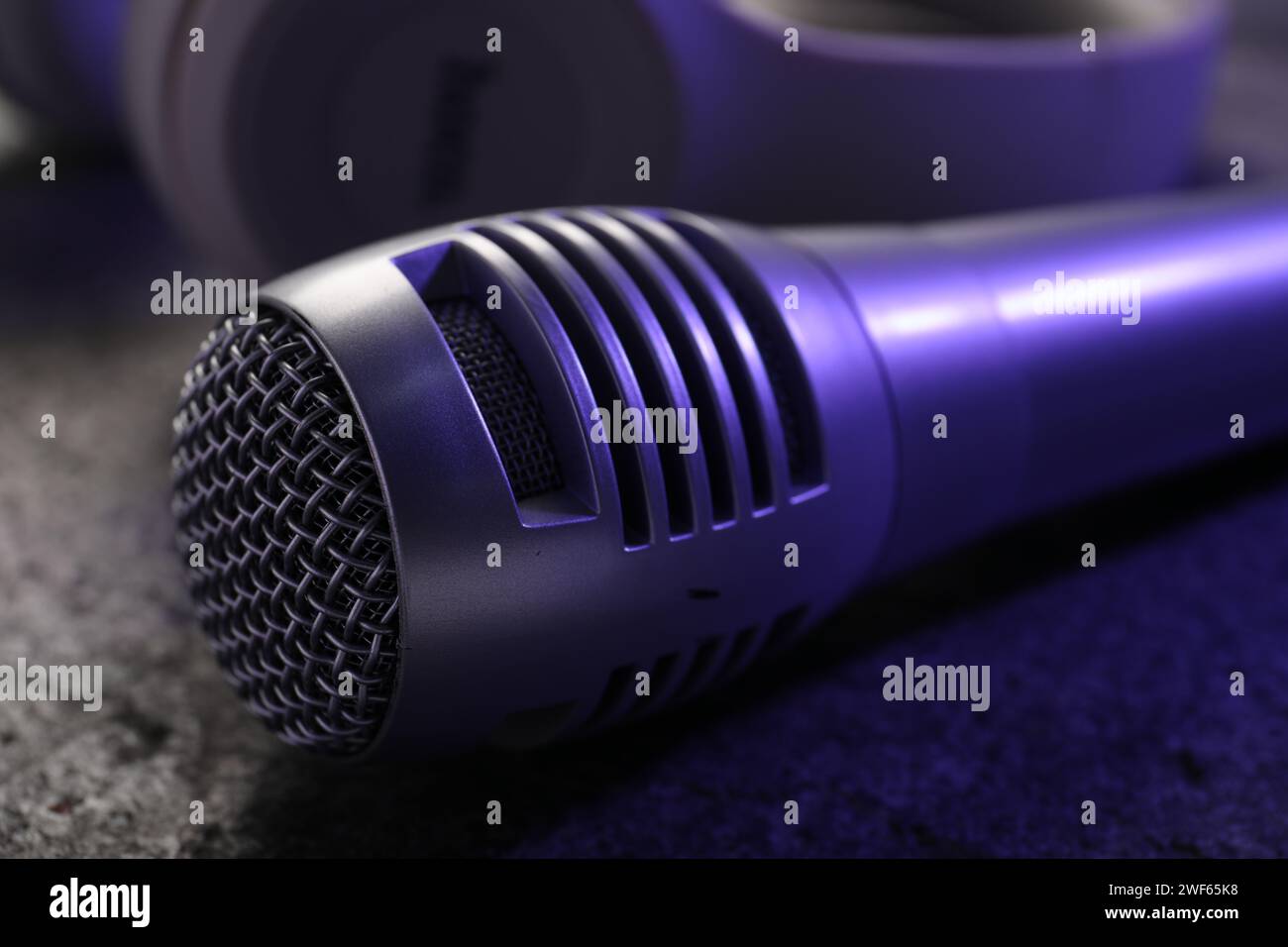 Microphone on grey textured table, closeup. Sound recording and ...
