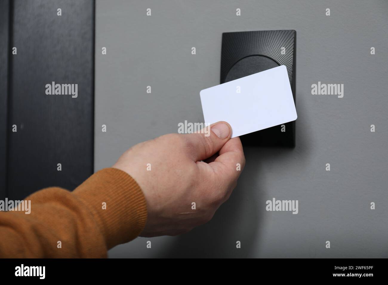 Man opening magnetic door lock with key card, closeup. Home security ...