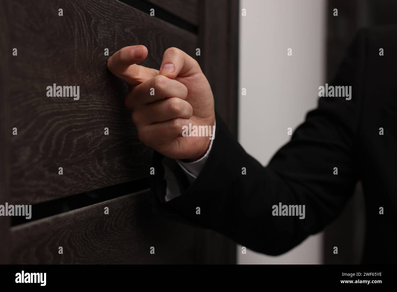 Collector knocking on door indoors, closeup view Stock Photo - Alamy