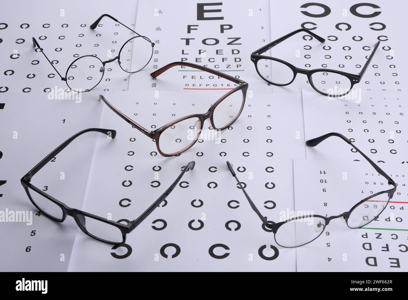 Vision test charts and glasses on table Stock Photo - Alamy