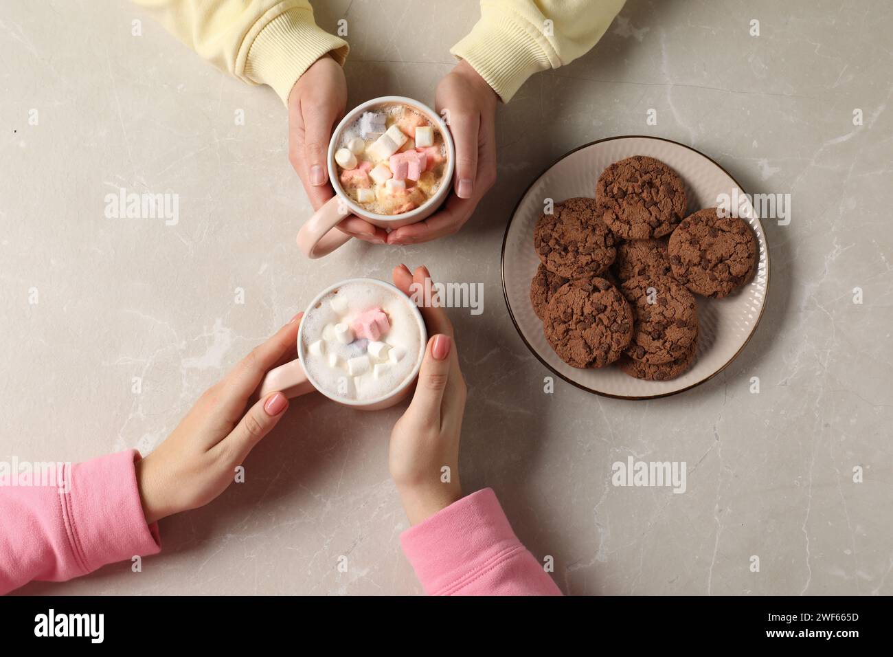Women having coffee break at marble table, top view Stock Photo - Alamy