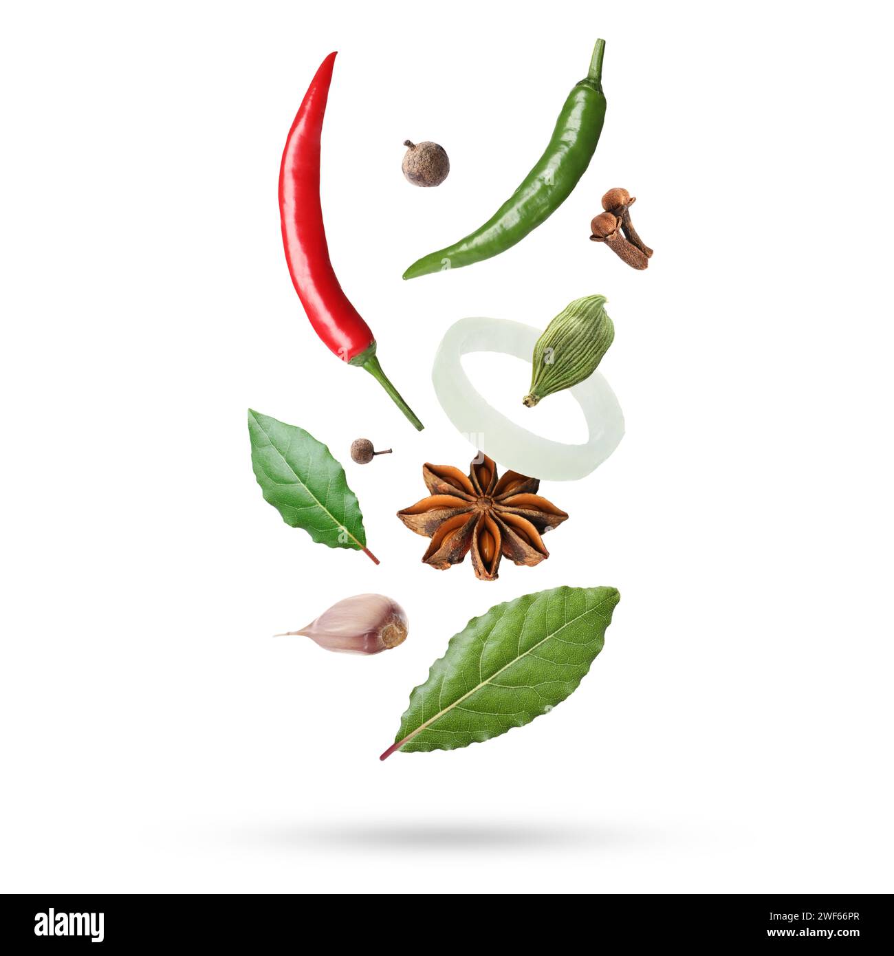 Different aromatic spices falling on white background Stock Photo - Alamy