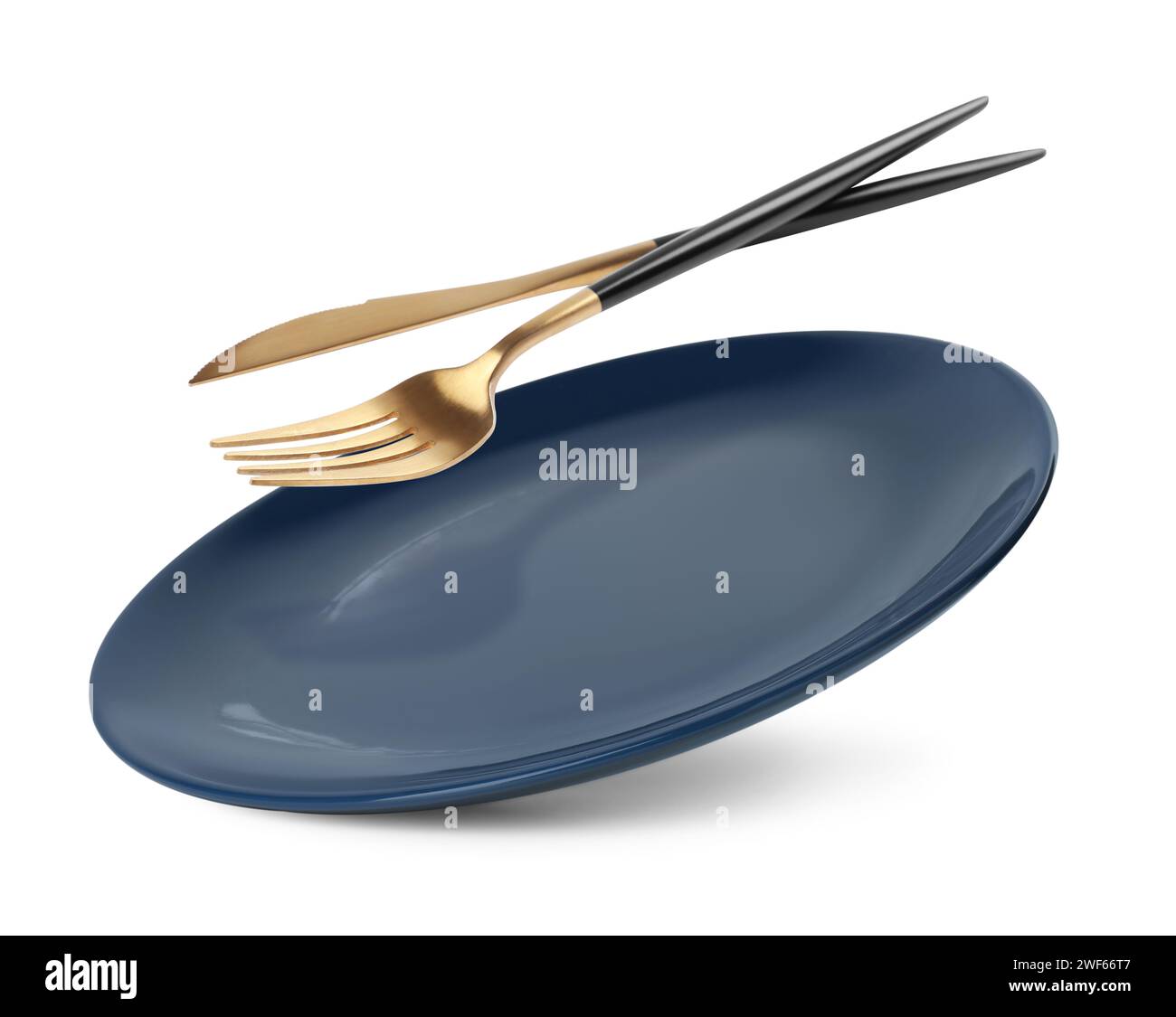 Clean plate, fork and knife falling on white background Stock Photo - Alamy
