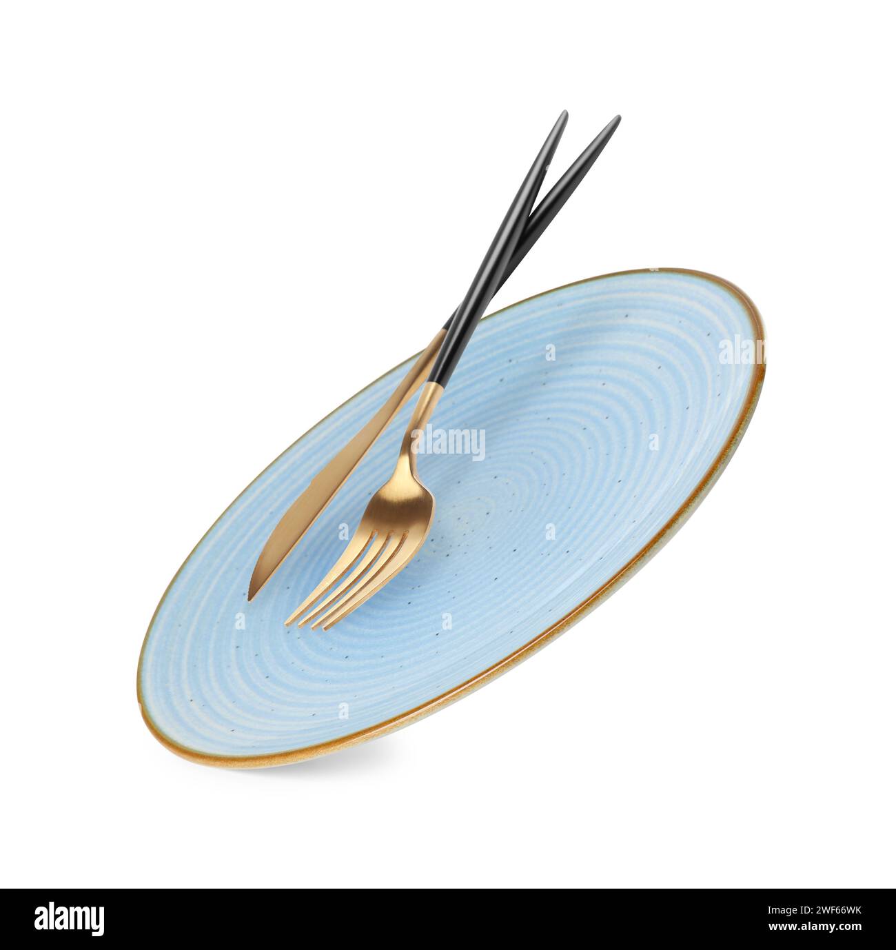 Clean plate, fork and knife falling on white background Stock Photo - Alamy