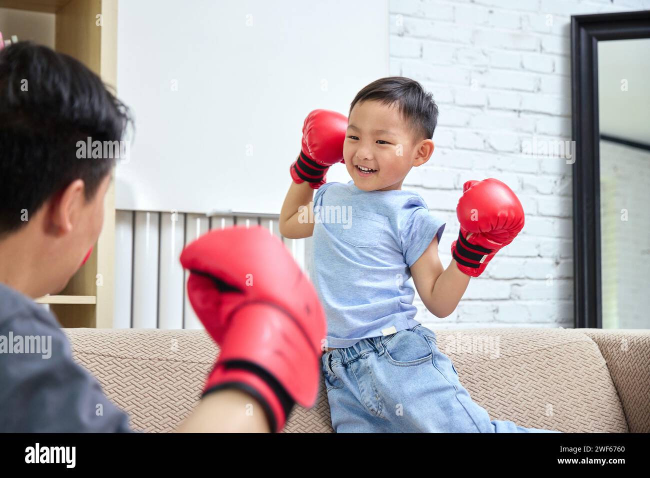 Father and son wearing boxing gloves Stock Photo - Alamy