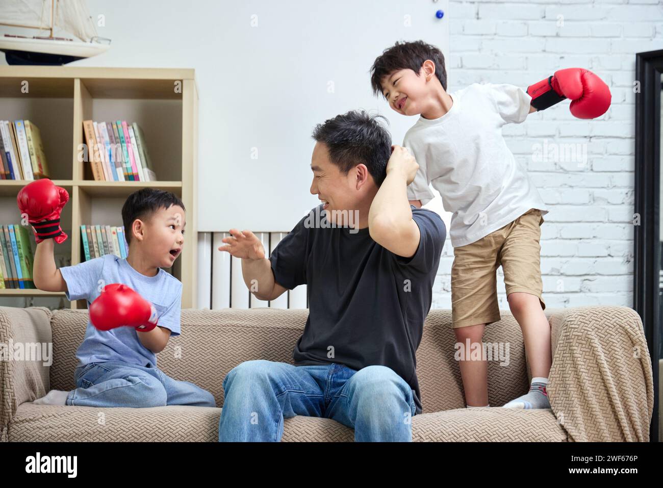 Father and son wearing boxing gloves Stock Photo - Alamy