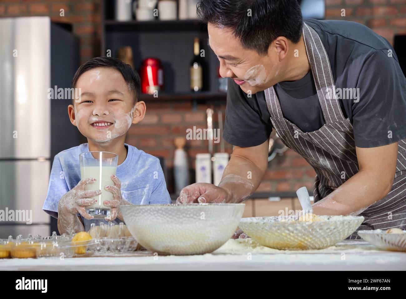 Father and son baking together Stock Photo - Alamy