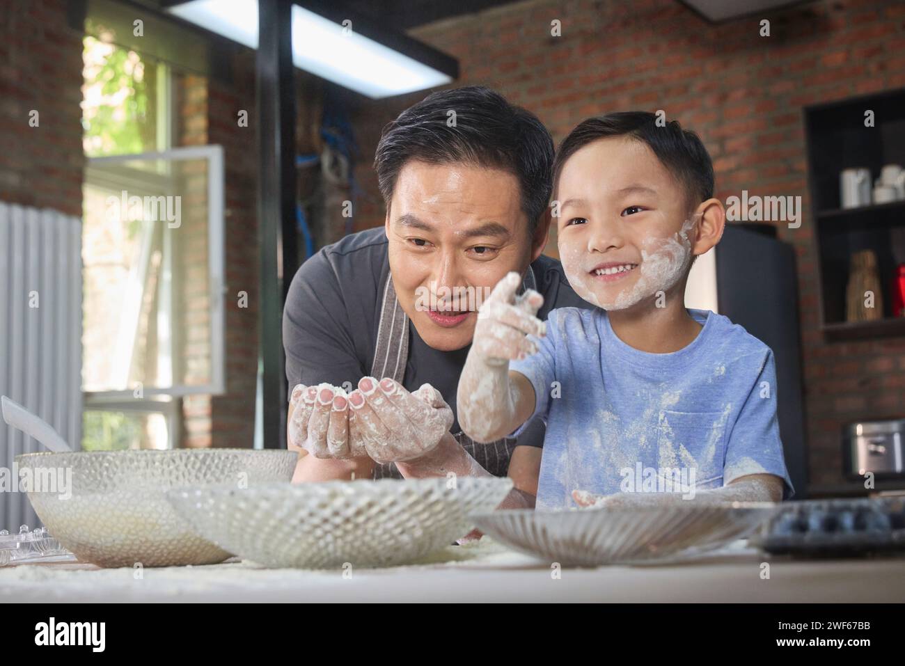 Father and son baking together Stock Photo - Alamy