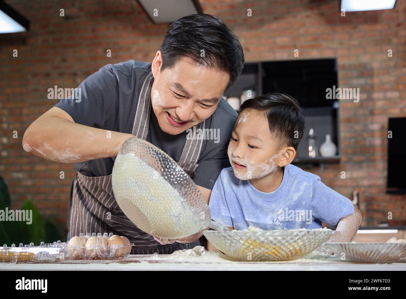 Father and son baking together Stock Photo - Alamy