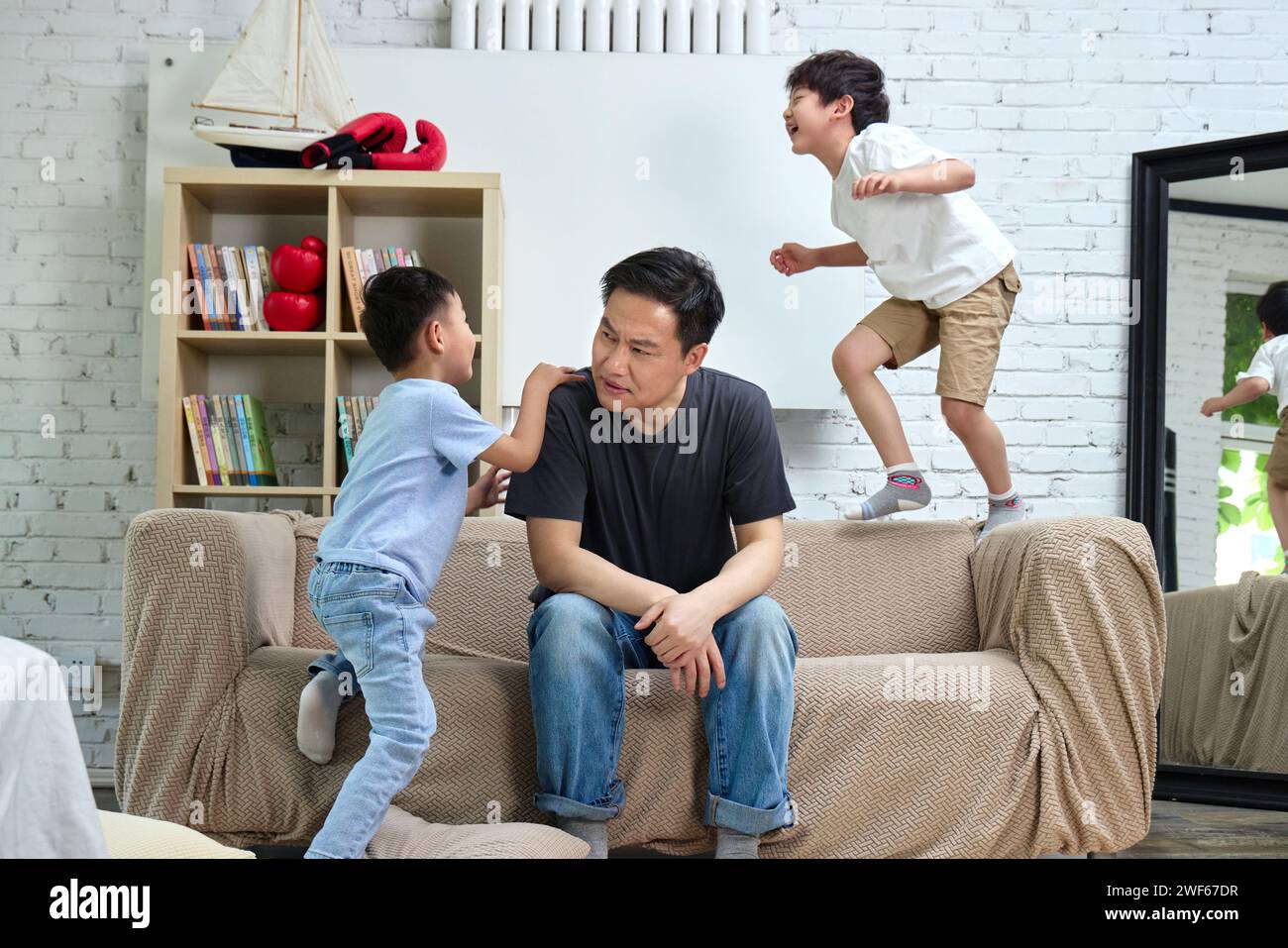 Father and children playing on the sofa Stock Photo - Alamy