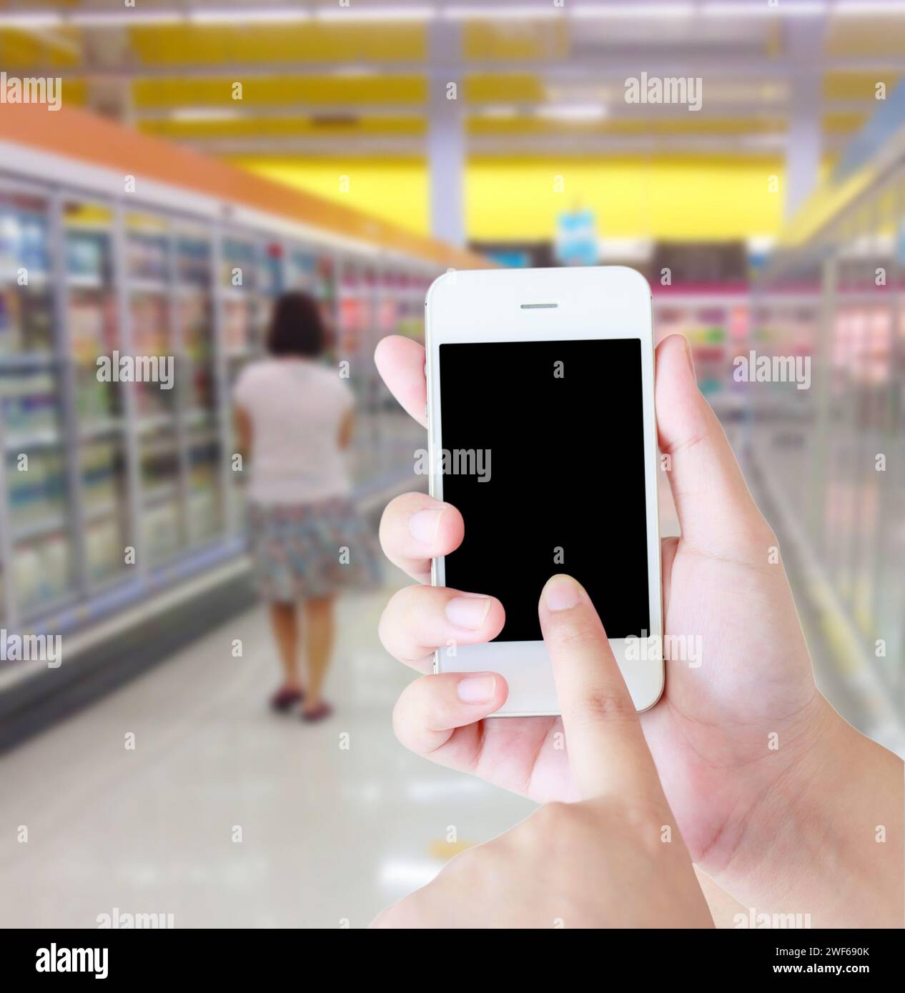 hand holding smartphone with Supermarket Aisle Milk Yogurt Frozen Food ...