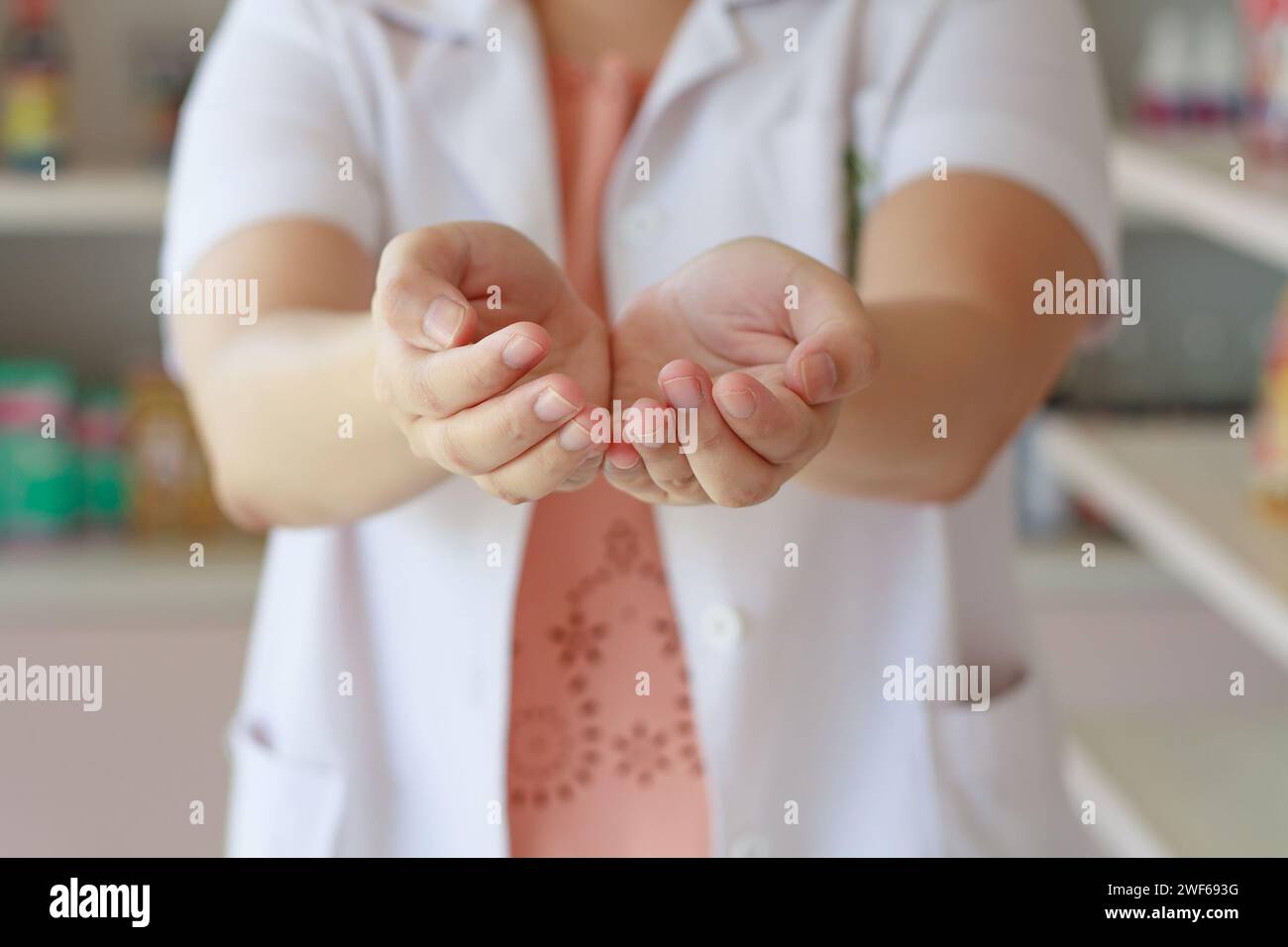 pharmacist with begging hands Stock Photo - Alamy