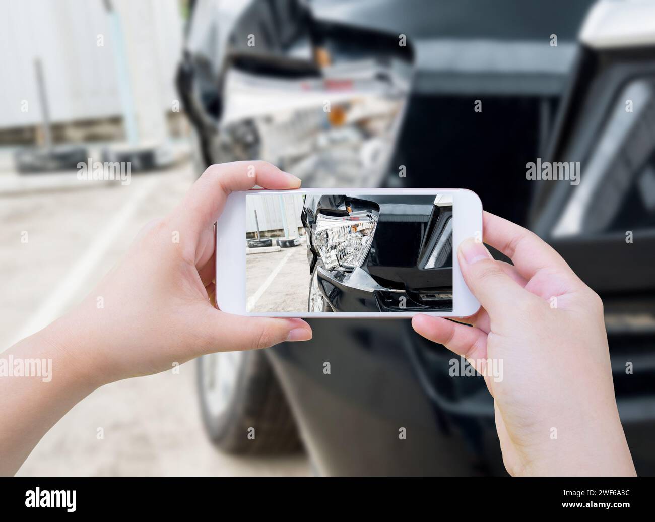 female hold mobile smartphone photographing car accident for insurance ...