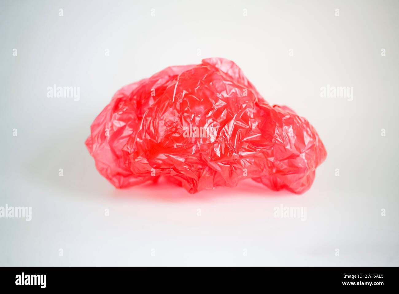 Crumpled red plastic bag isolated on white background Stock Photo - Alamy