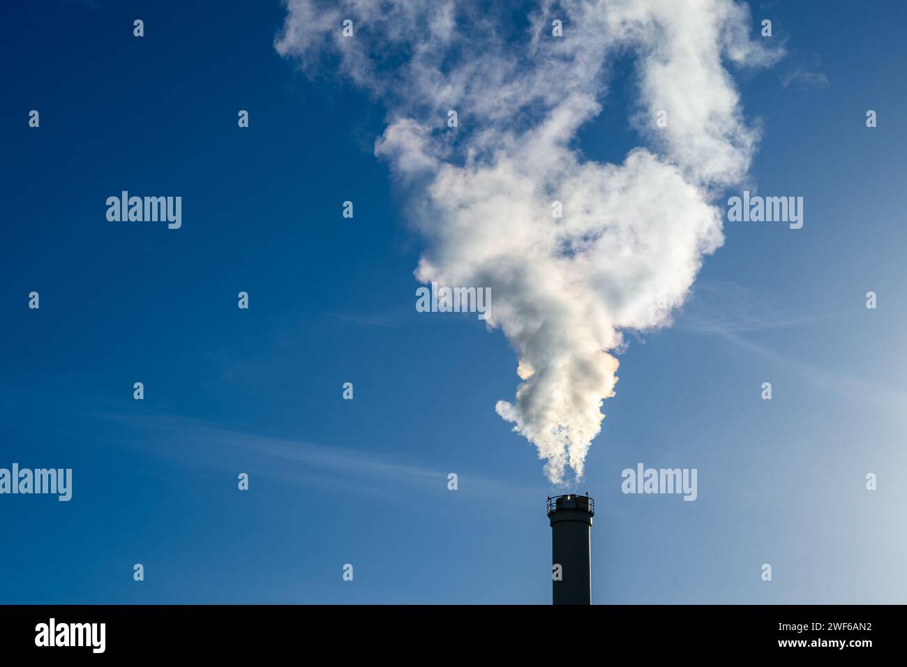 Chimney of a modern combined heat and power plant Stock Photo - Alamy