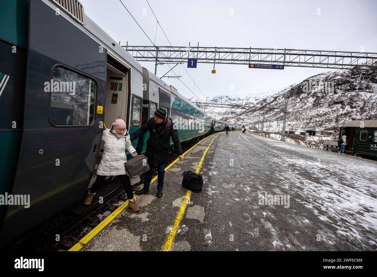 Passengers are seen getting off one of the carriages of a train at ...