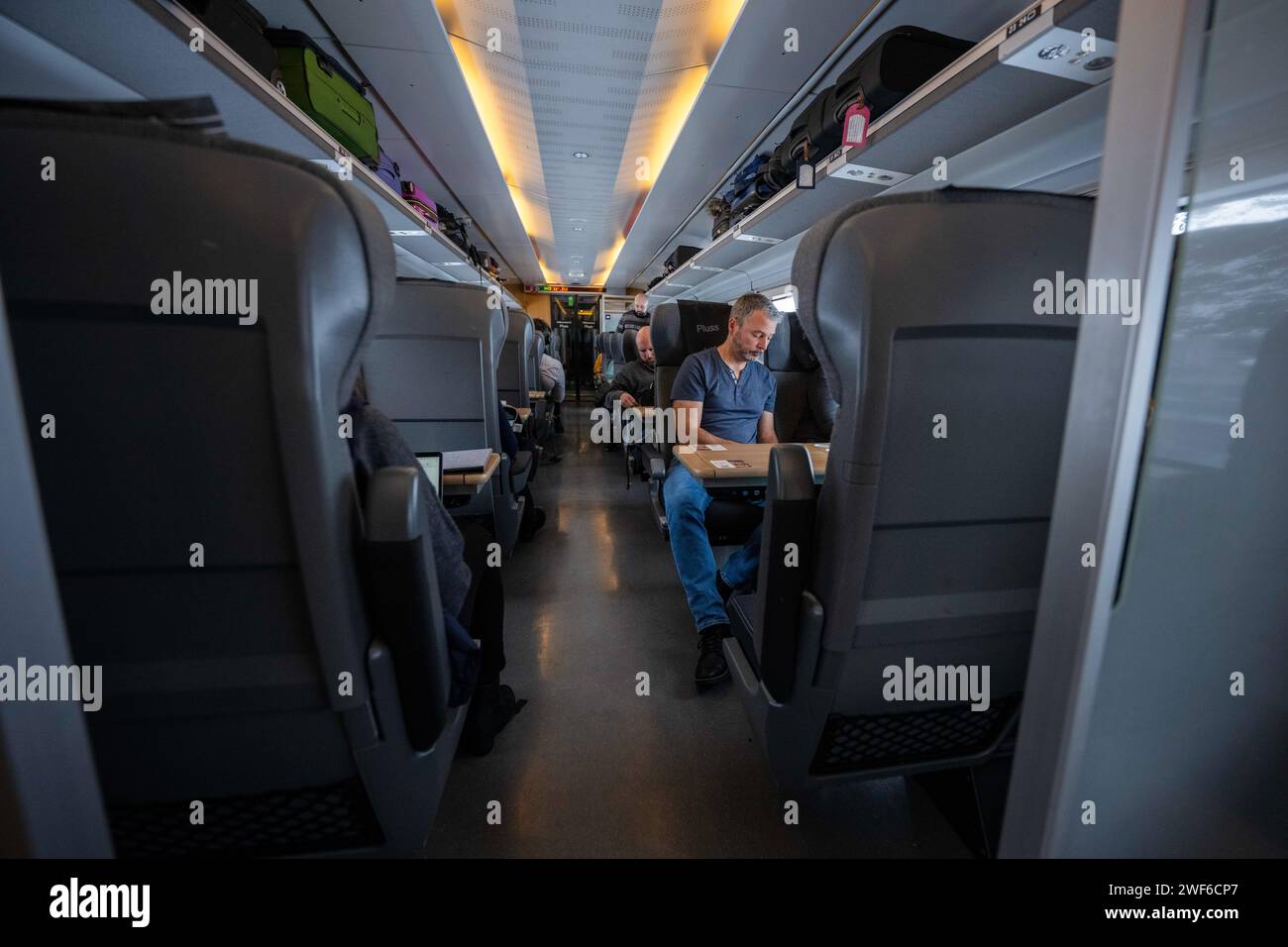 Passengers are seen resting in one of the carriages during a train run ...