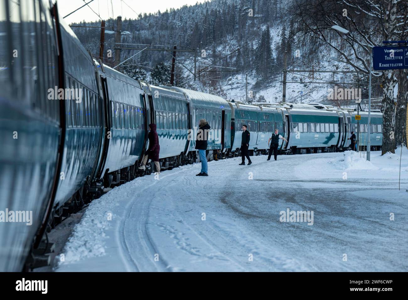 Several passengers are seen at the ?l station boarding a train that ...