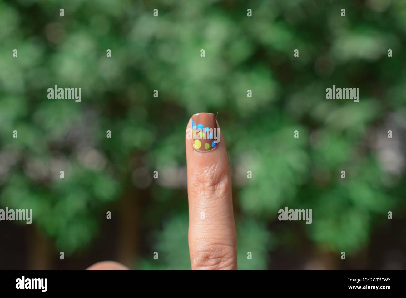 Nail art designs, Handmade dots nail design on female index finger ...